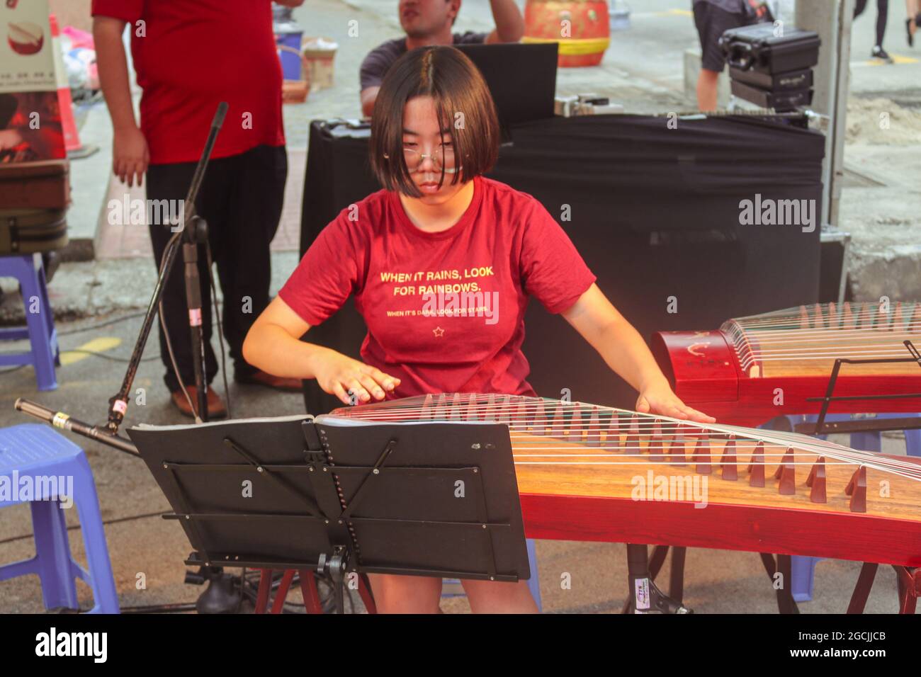 Closeup shot of Chinese woman playing a Chinese instrument on the ...