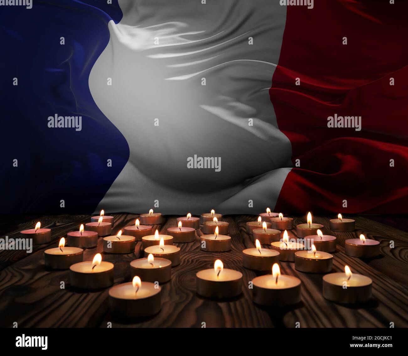 Mourning candles burning on France national flag of background ...