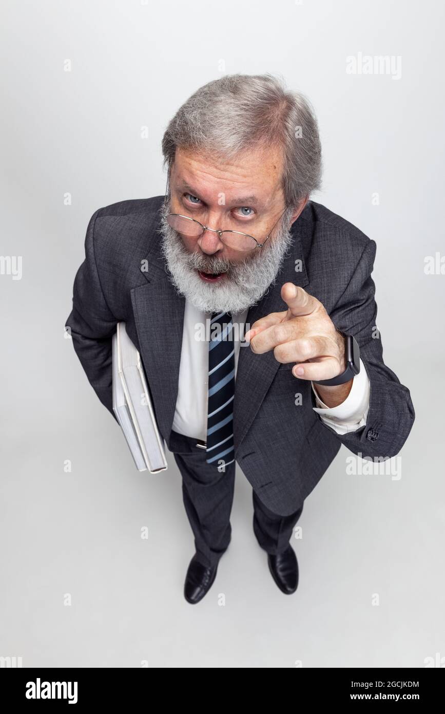 High angle view of elderly gray-headed man, professor, teacher posing ...