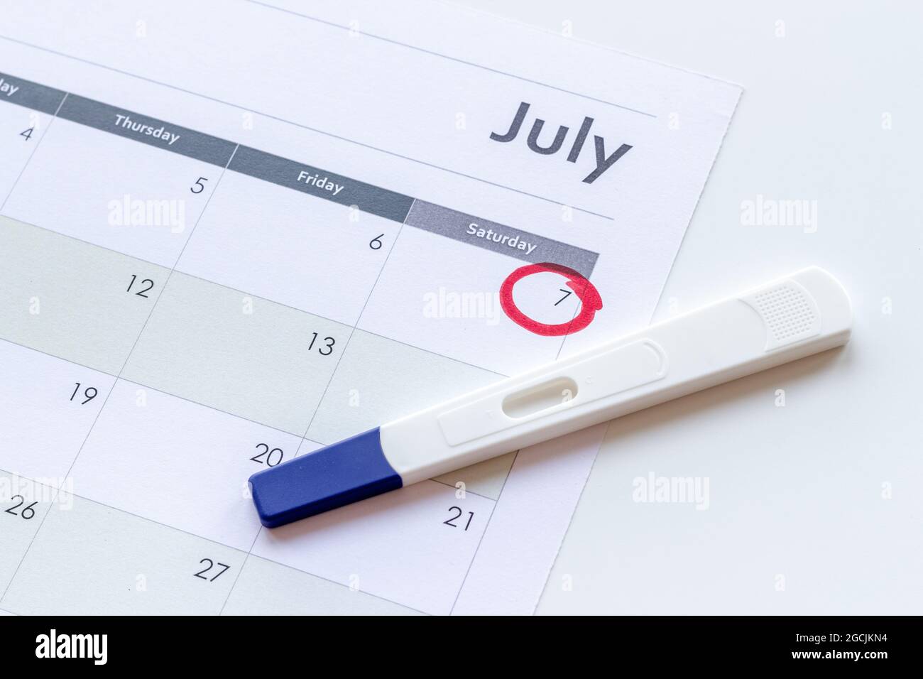 Pregnancy test on calendar. Time to check pregnancy day Stock Photo - Alamy