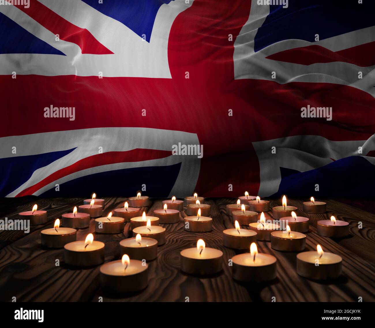 Mourning candles burning on Great Britain national flag of background ...