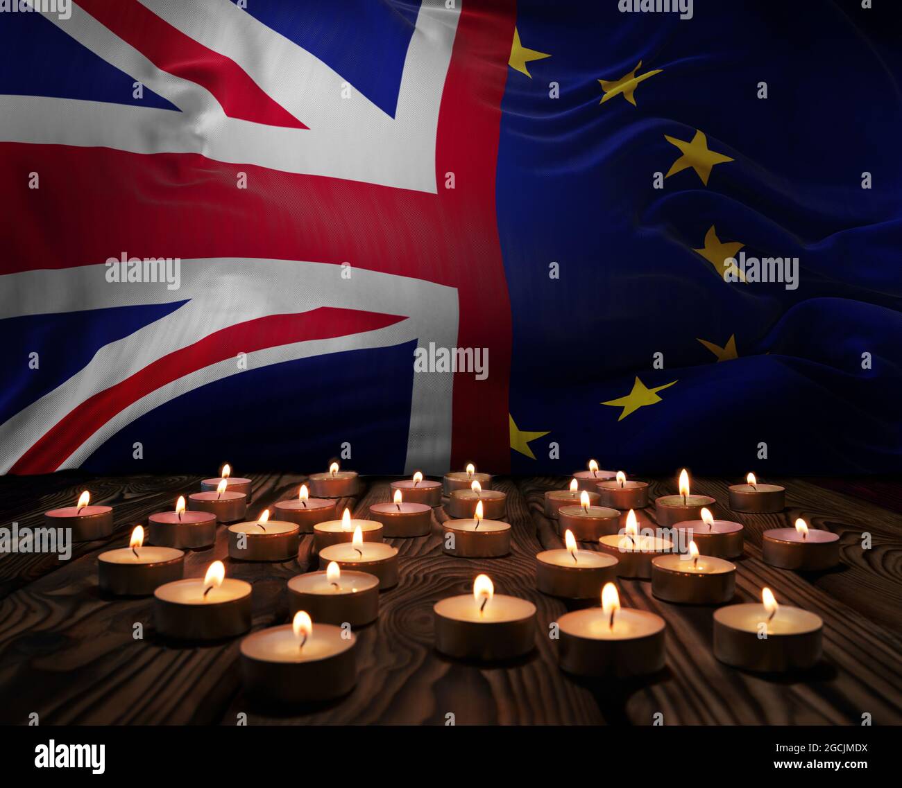 Mourning candles burning on Union Jack And European Union flags ...