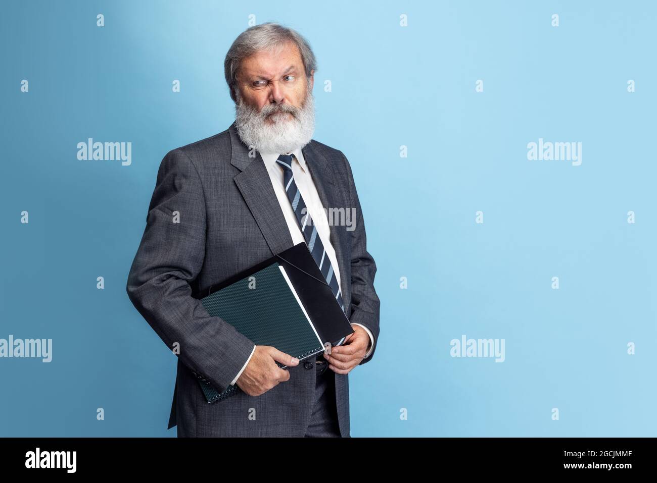 Portrait of elder gray-headed man, professor, teacher working at work ...