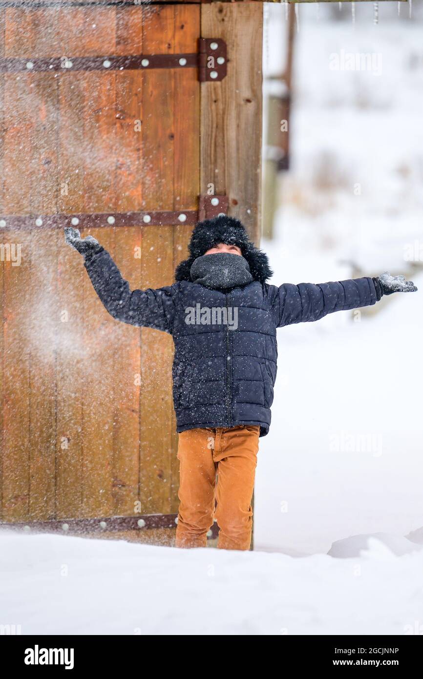 The boy enjoys a walk in the snow, a fun winter time for children's ...