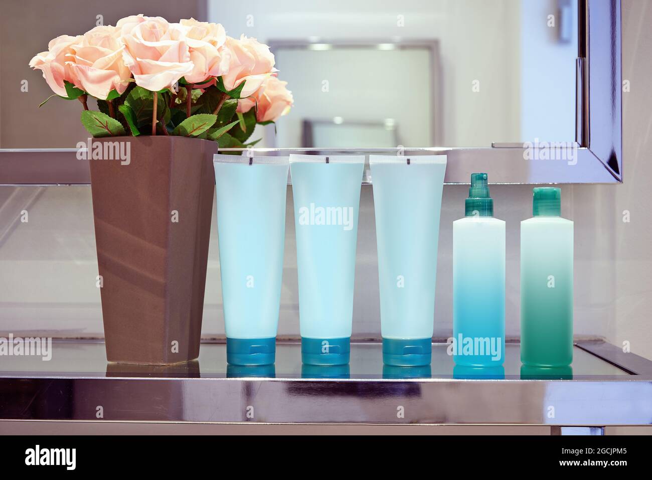 Family cosmetics tubes and dispenser packaging in salon Stock Photo - Alamy