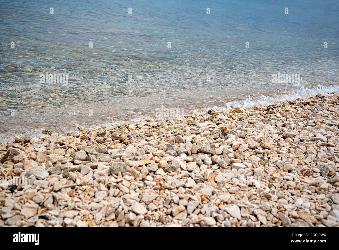 Small pebbles on the seashore Stock Photo - Alamy