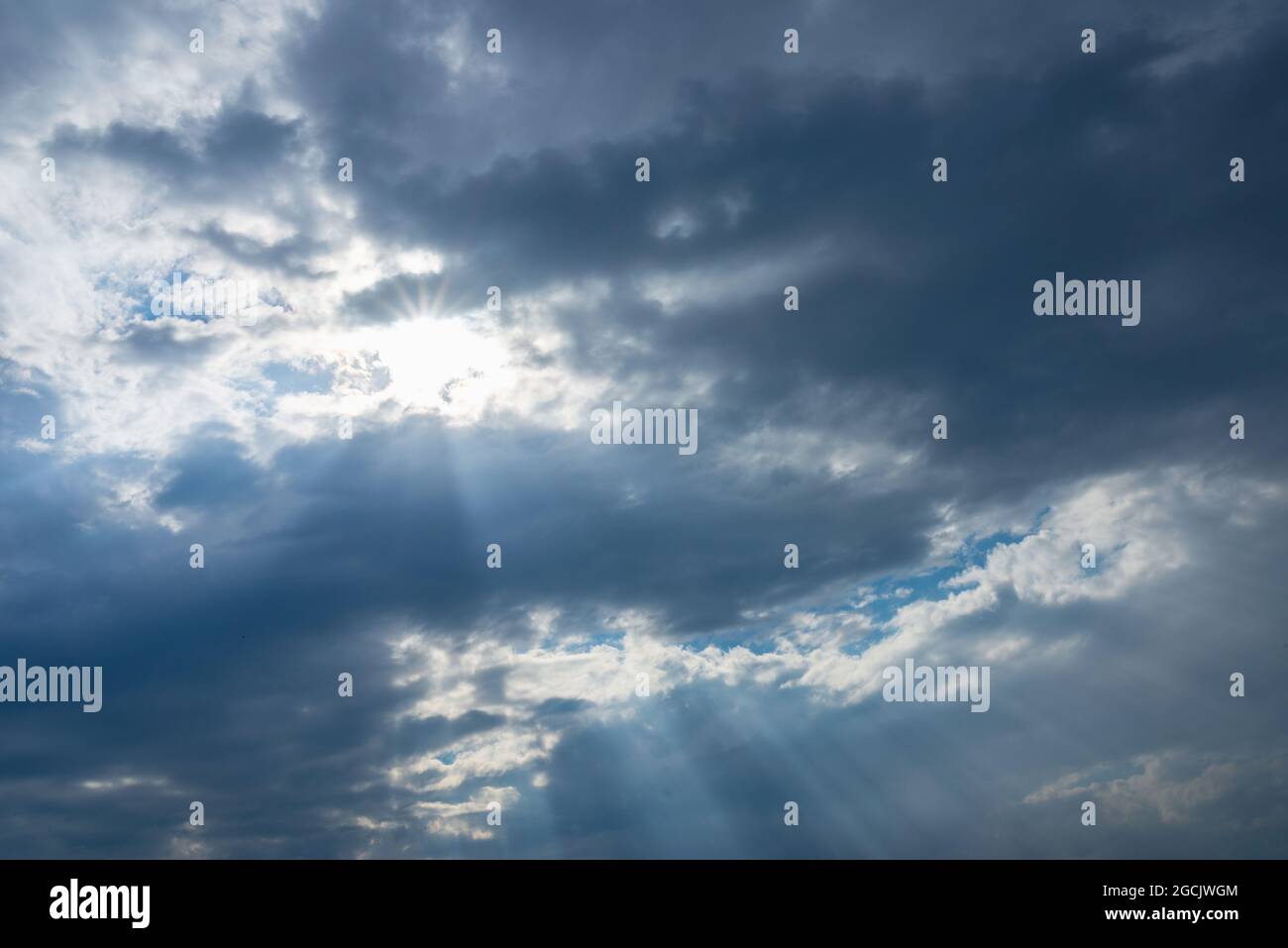 Dramatic blue sky with clouds and sun rays.Summer Sun rays at evening ...