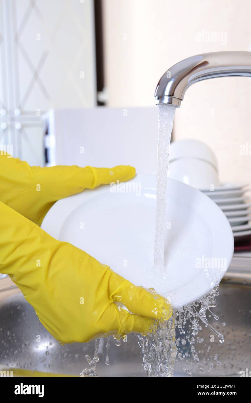Close up hands of woman washing dishes in kitchen Stock Photo - Alamy