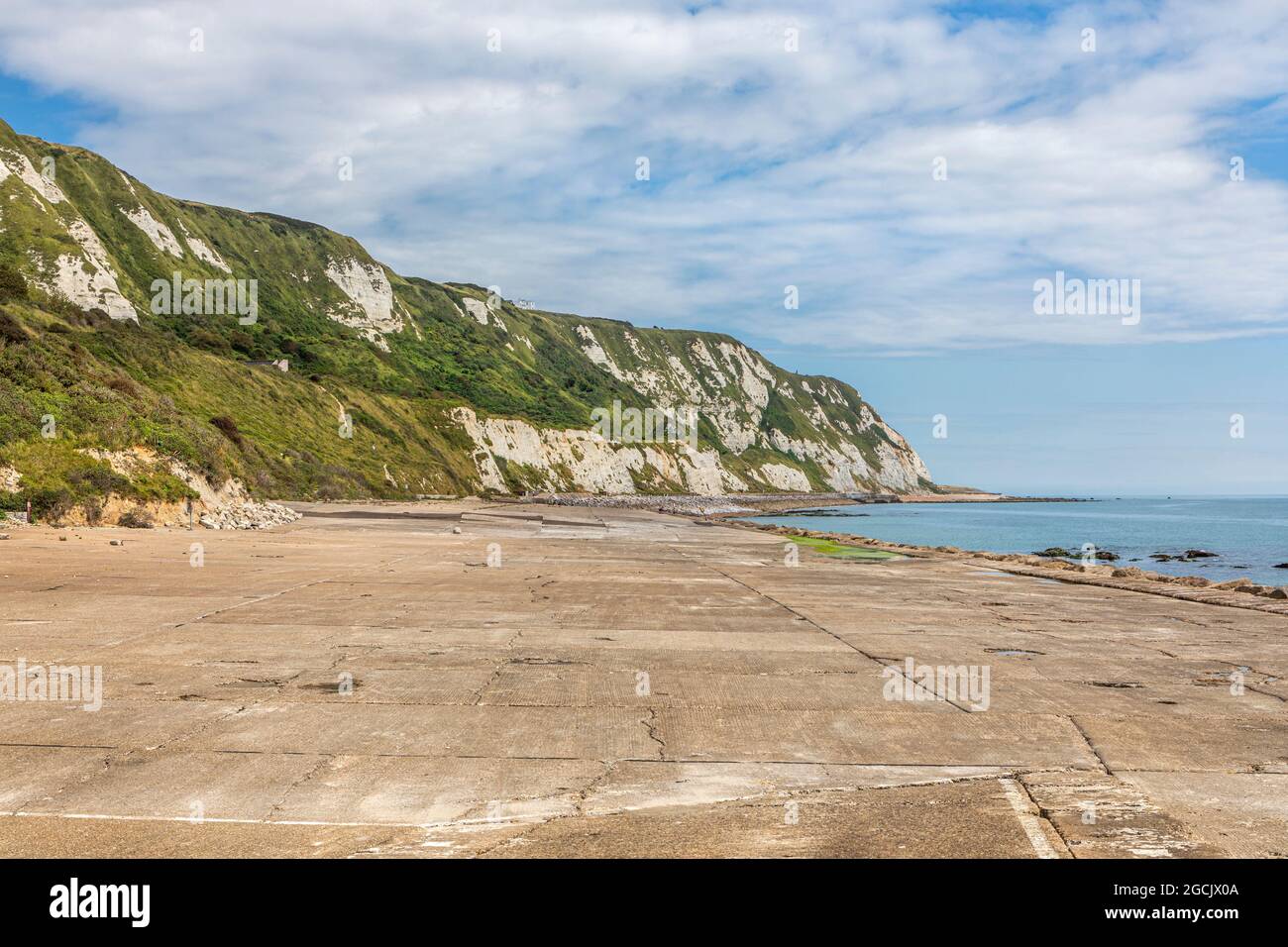The concrete sea defenses and white cliffs at Folkestone Warren, Kent ...