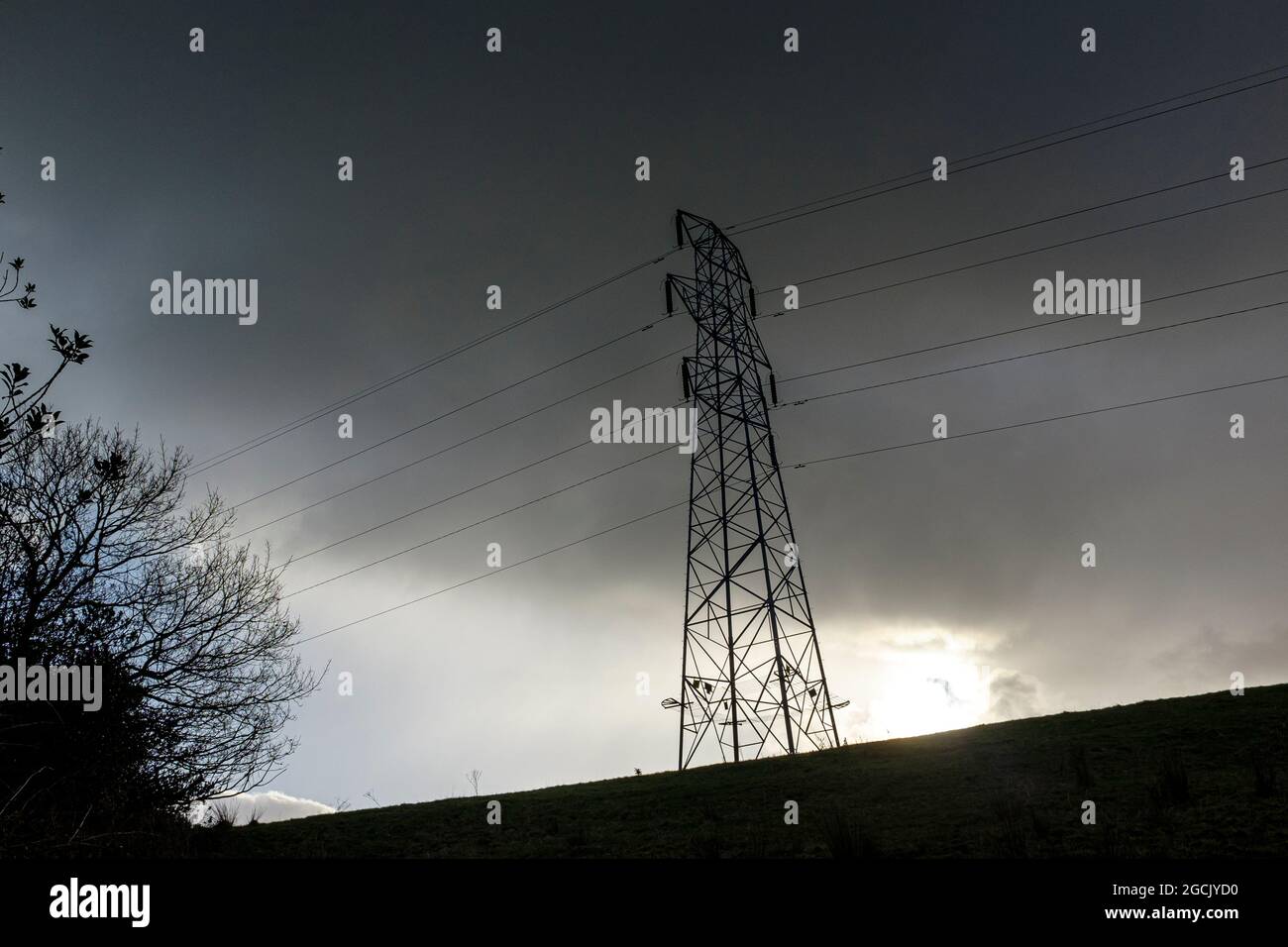 Electricity power pylon against a stormy sky Stock Photo - Alamy