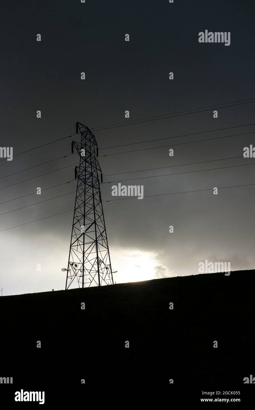 Electricity power pylon against a stormy sky Stock Photo - Alamy