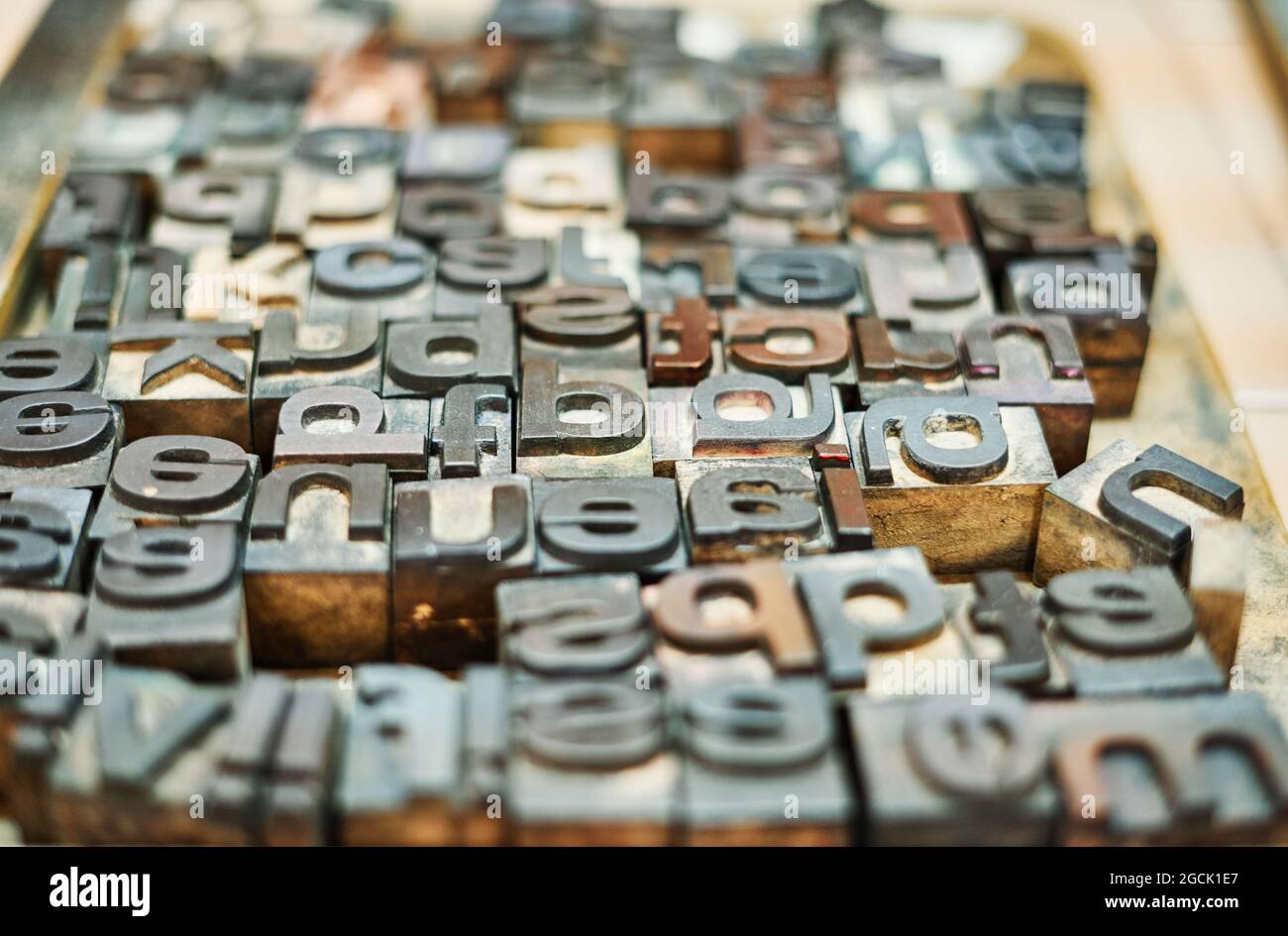 Set of metal shabby letterpress letters and numbers placed in wooden ...