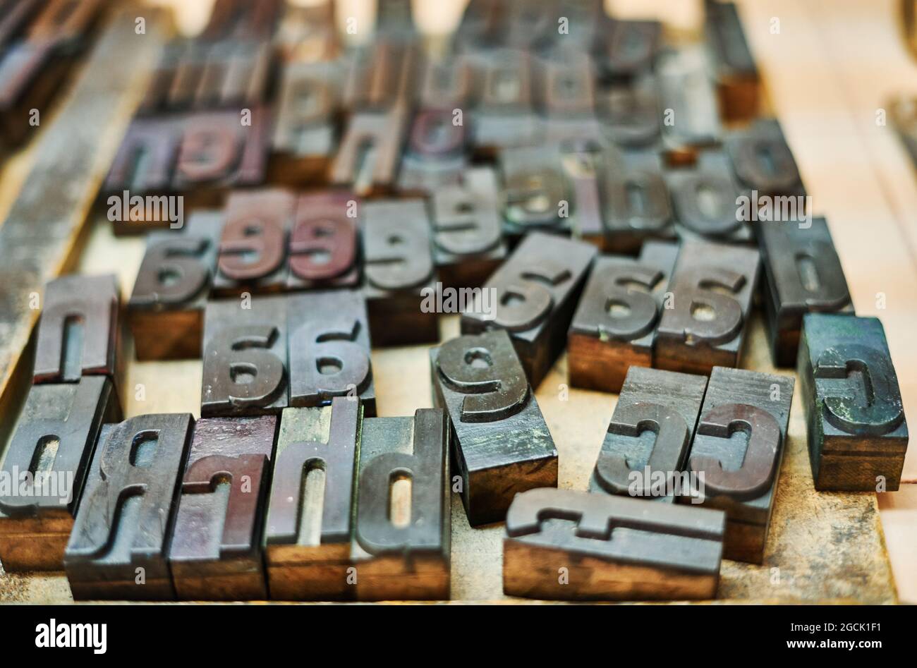 Set of metal shabby letterpress letters and numbers placed in wooden ...