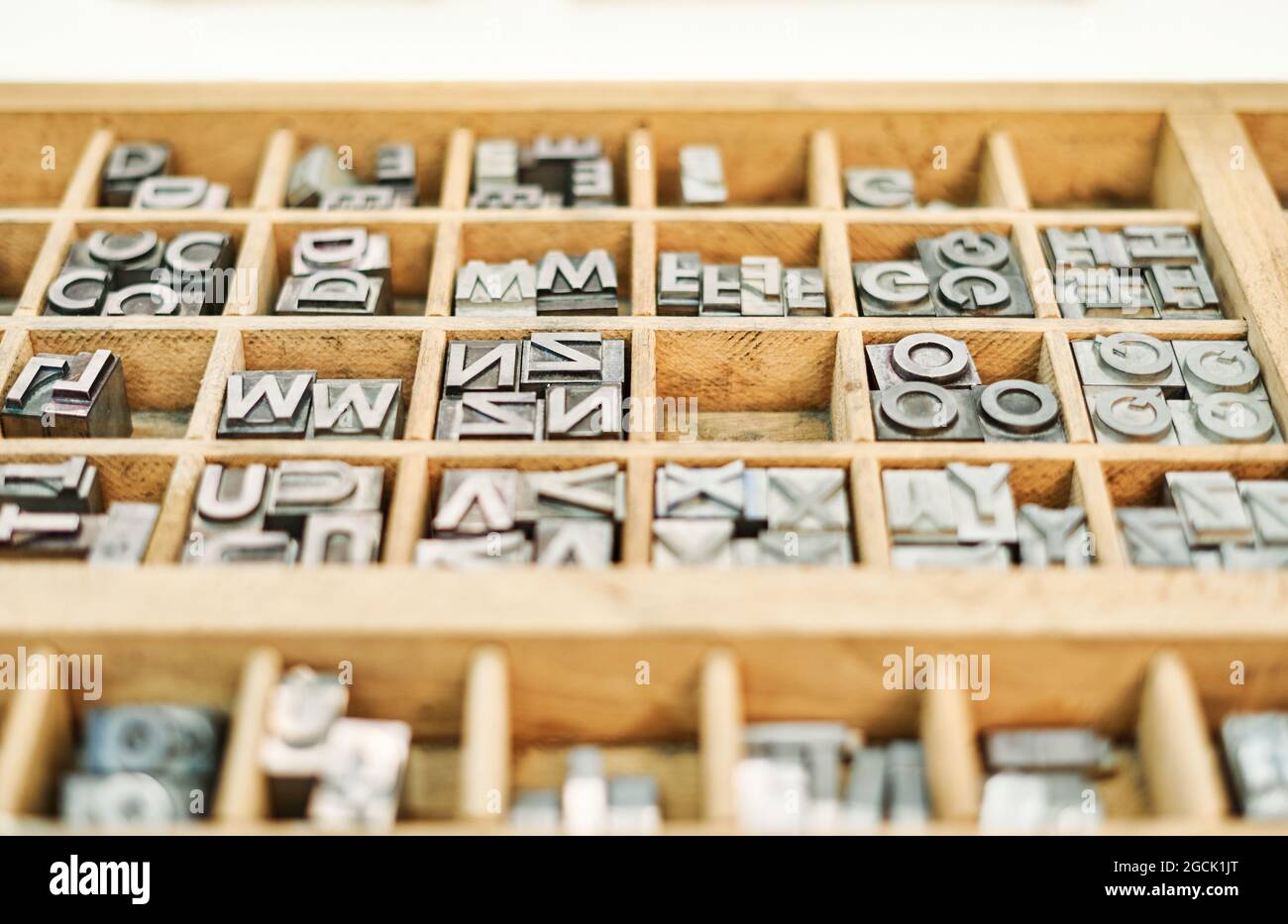 Set of metal shabby letterpress letters placed in wooden box in ...