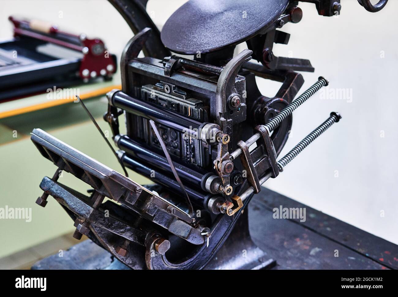 Retro shabby letterpress machine with metal details placed on wooden ...