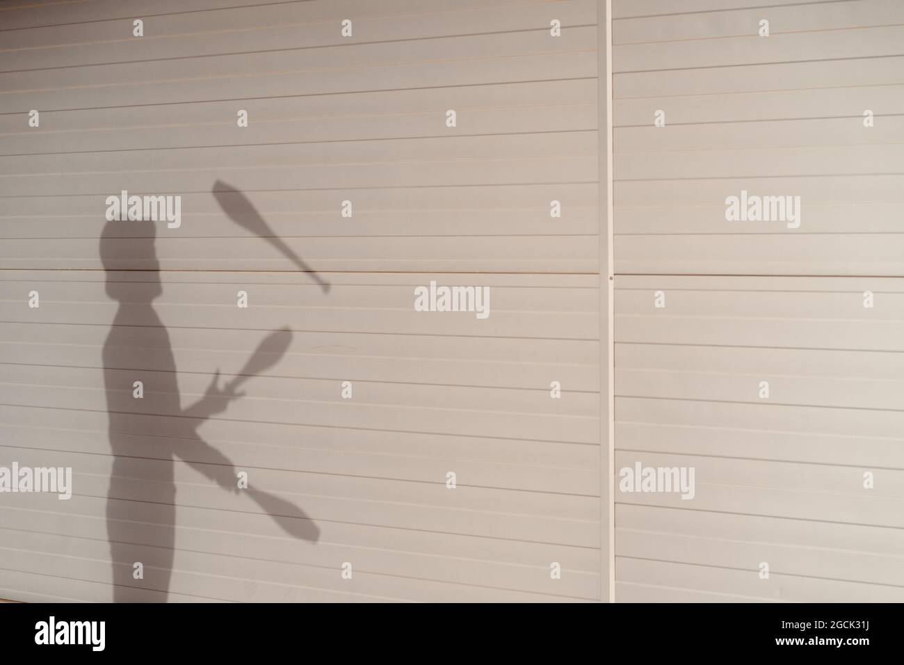 Side view shadow of anonymous talented male circus performer in hat ...