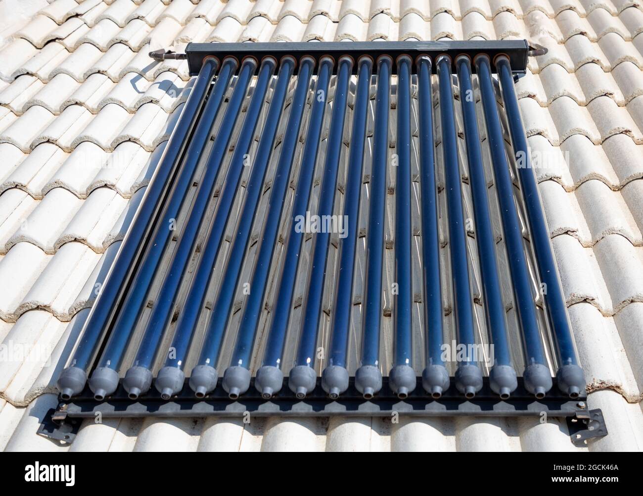Close up of evacuated tubes on a rooftop. Evacuated tubes are used to ...