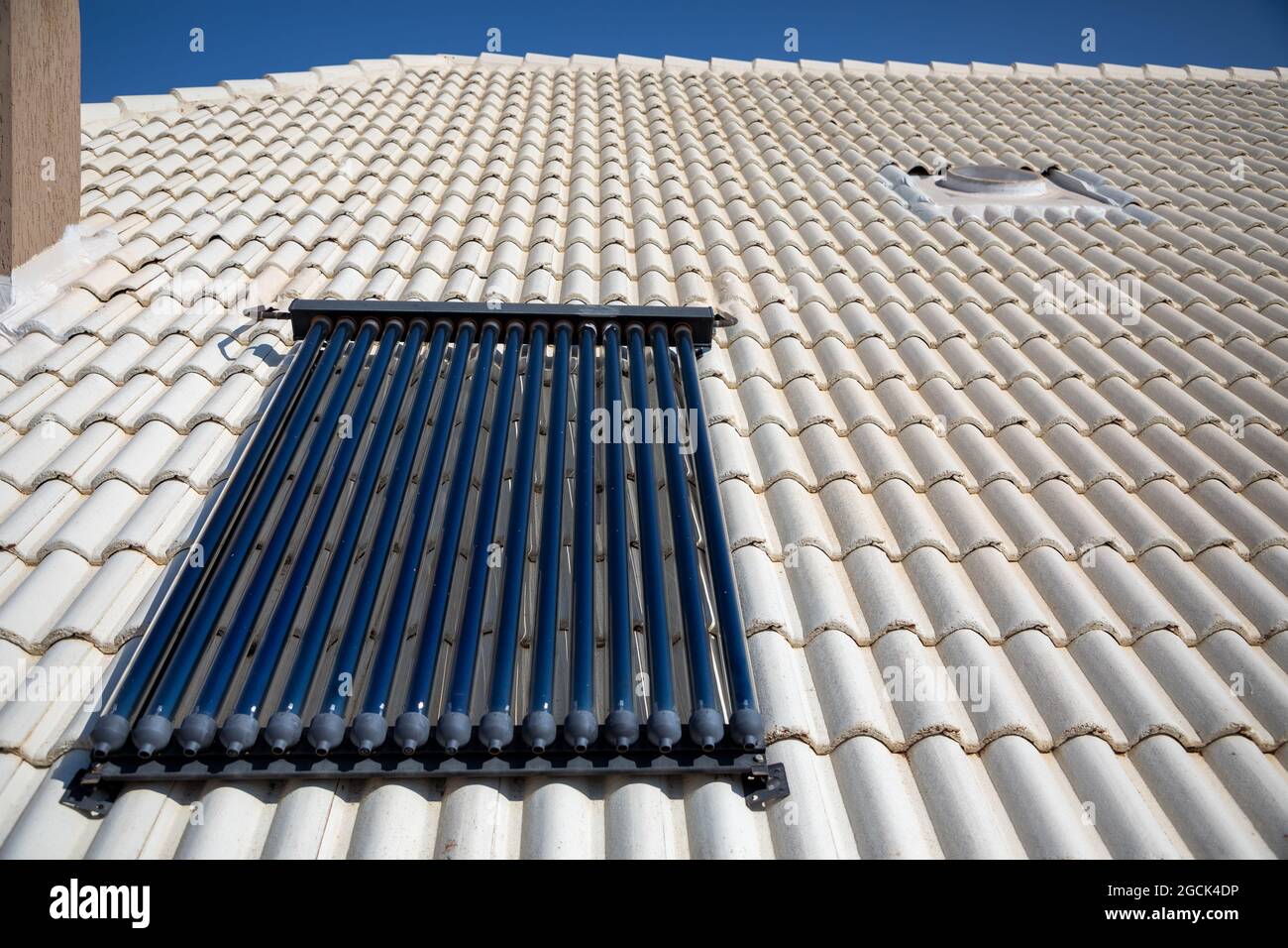 Solar panels on roof with a glass skylight for extra light in a ...