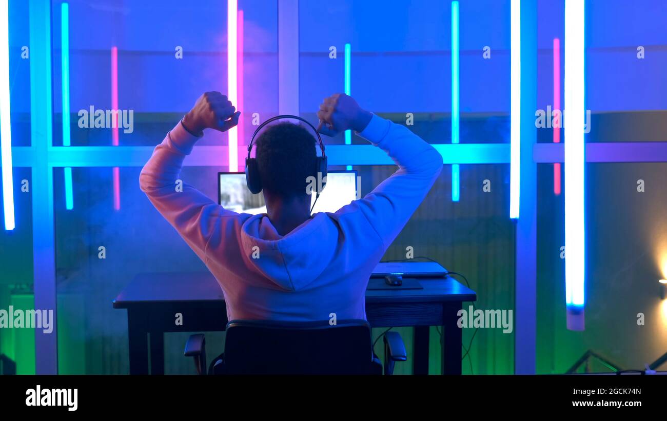 Back view of young gamer winning online game. He playing on his ...