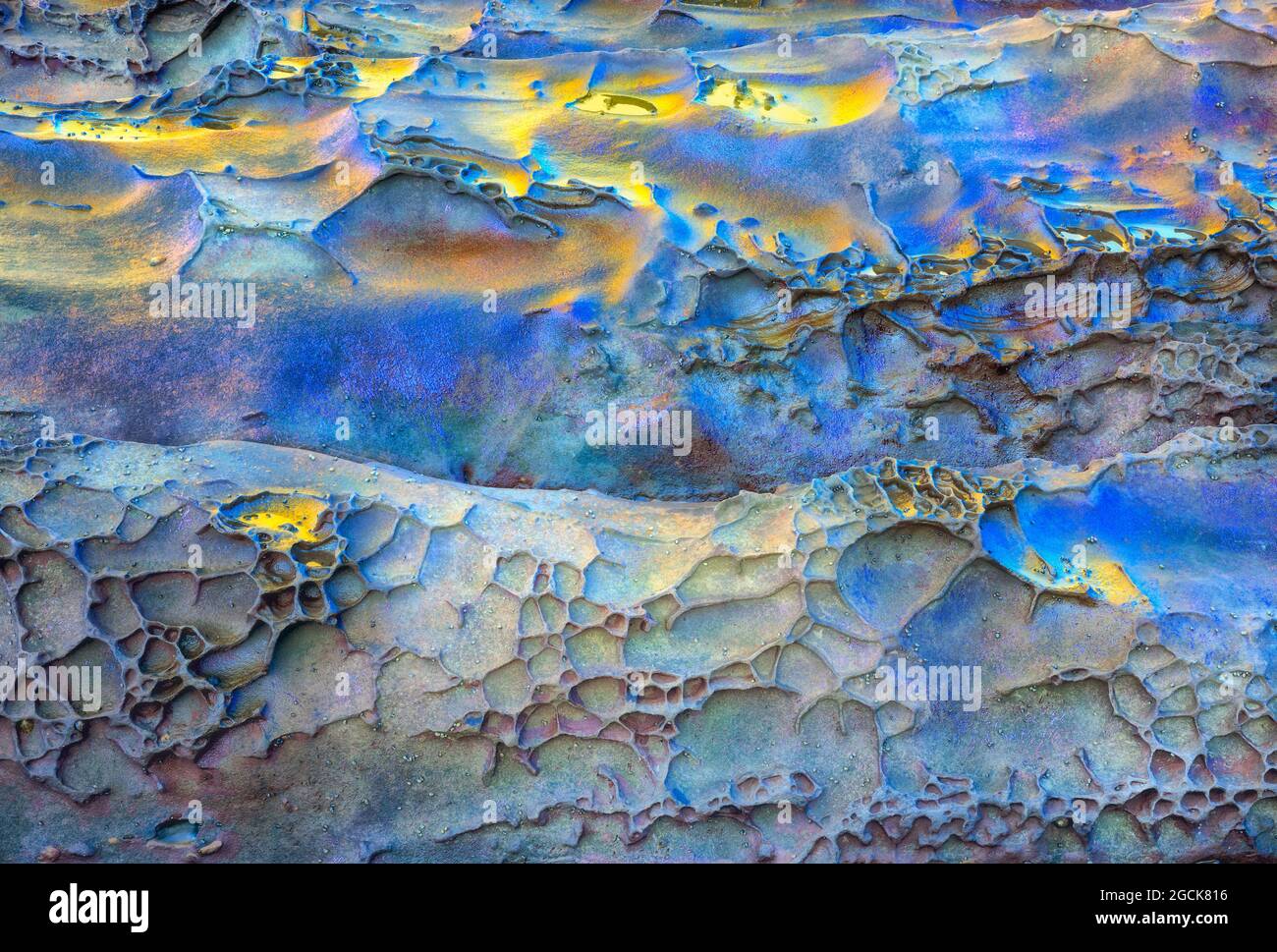 Textured background of solid rocky surface with layers of blue and ...