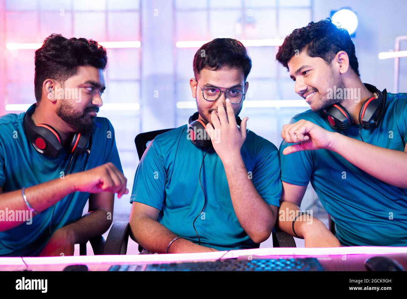 Group of professional gamers talking during video game play at esports ...