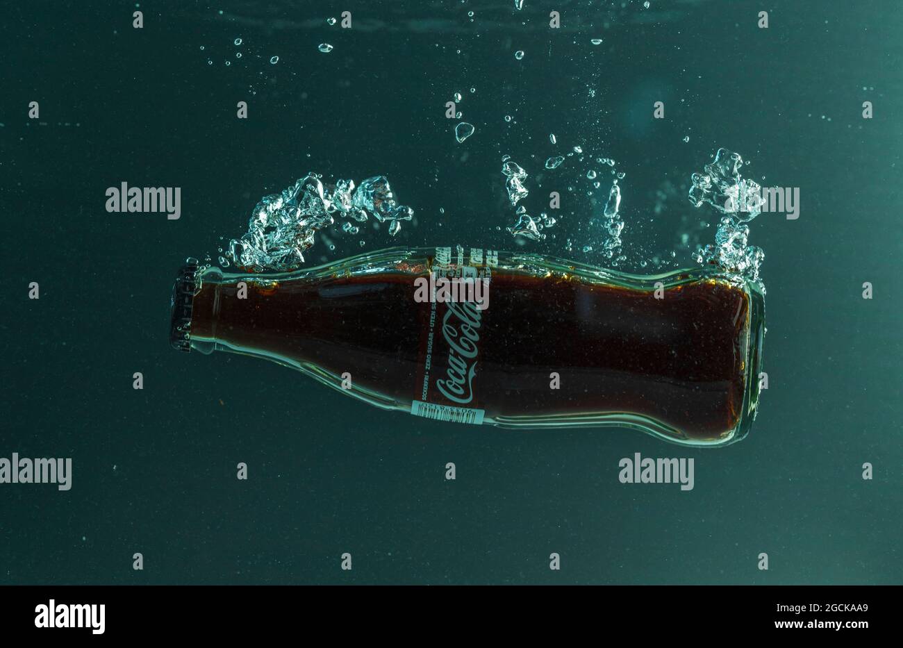 Close up view of Coca cola bottle falling in water Stock Photo - Alamy