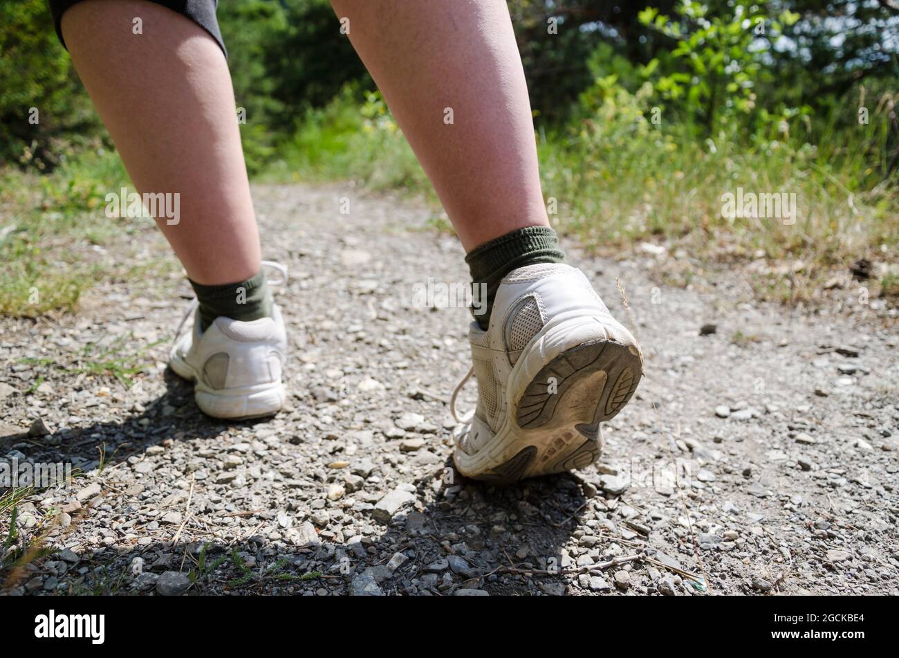 Back view of hiker legs walking on a path Stock Photo - Alamy