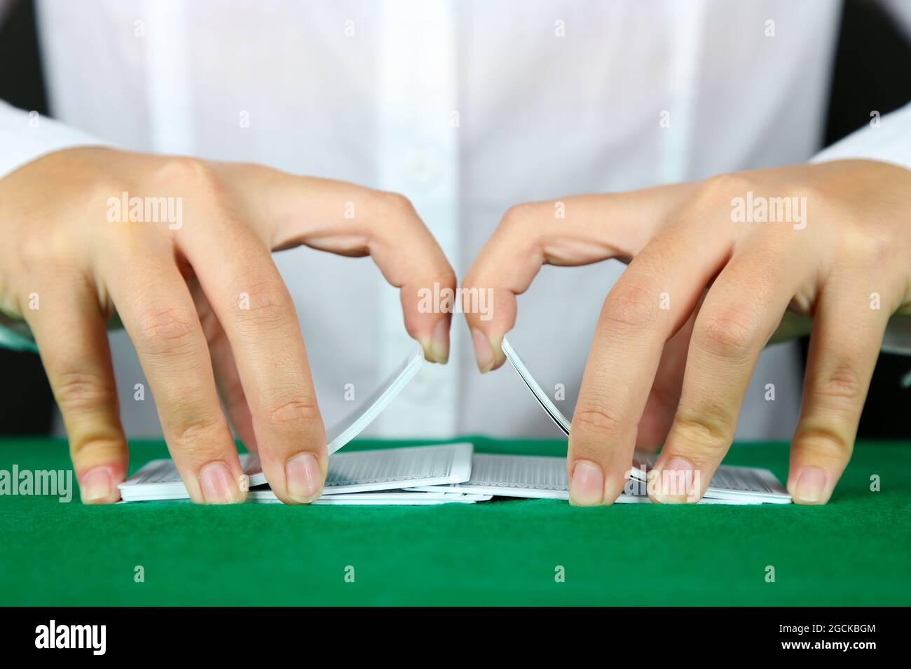 Playing cards in hands close up Stock Photo - Alamy