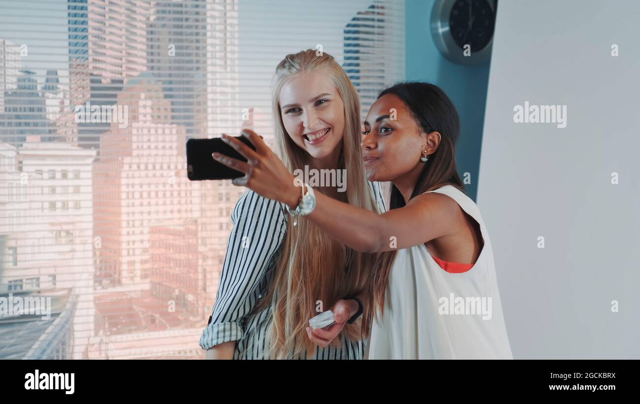 Behind the scenes on photo shoot: make-up artist applying makeup on ...