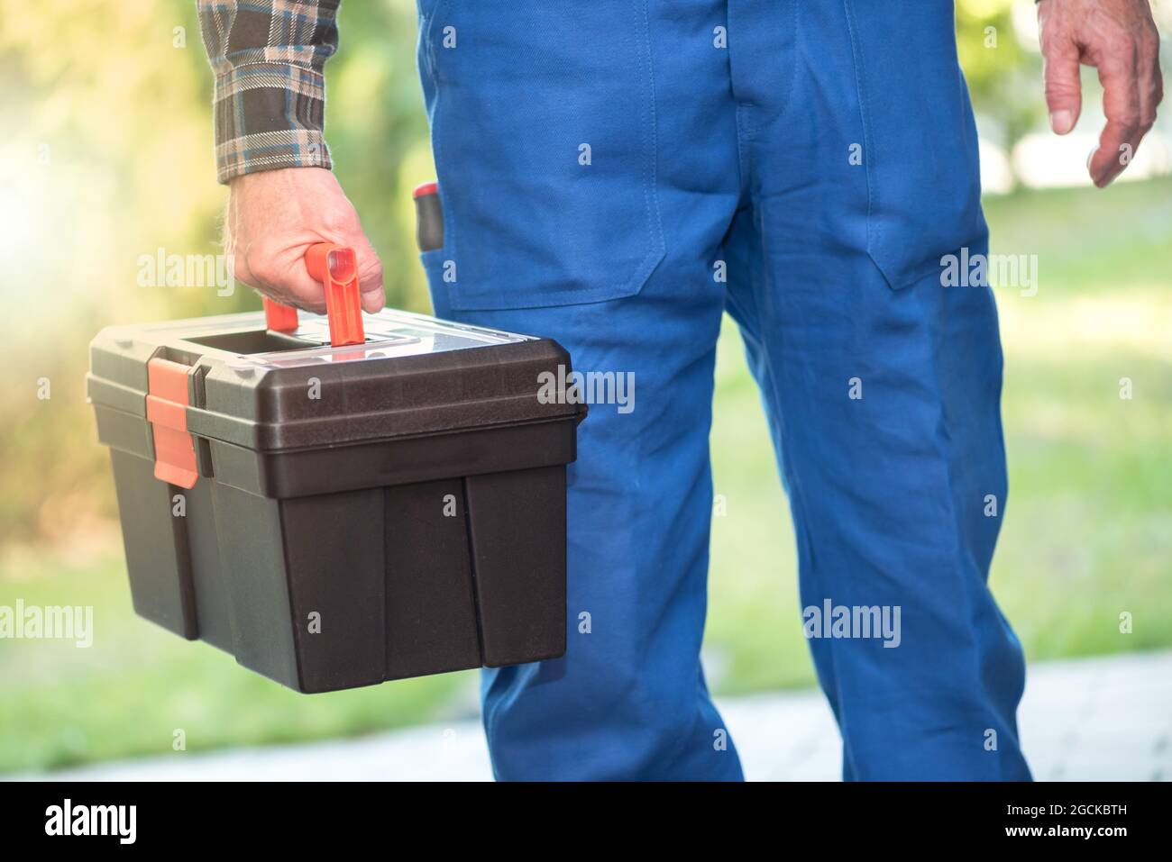 Repairman with his toolbox, light effect Stock Photo - Alamy