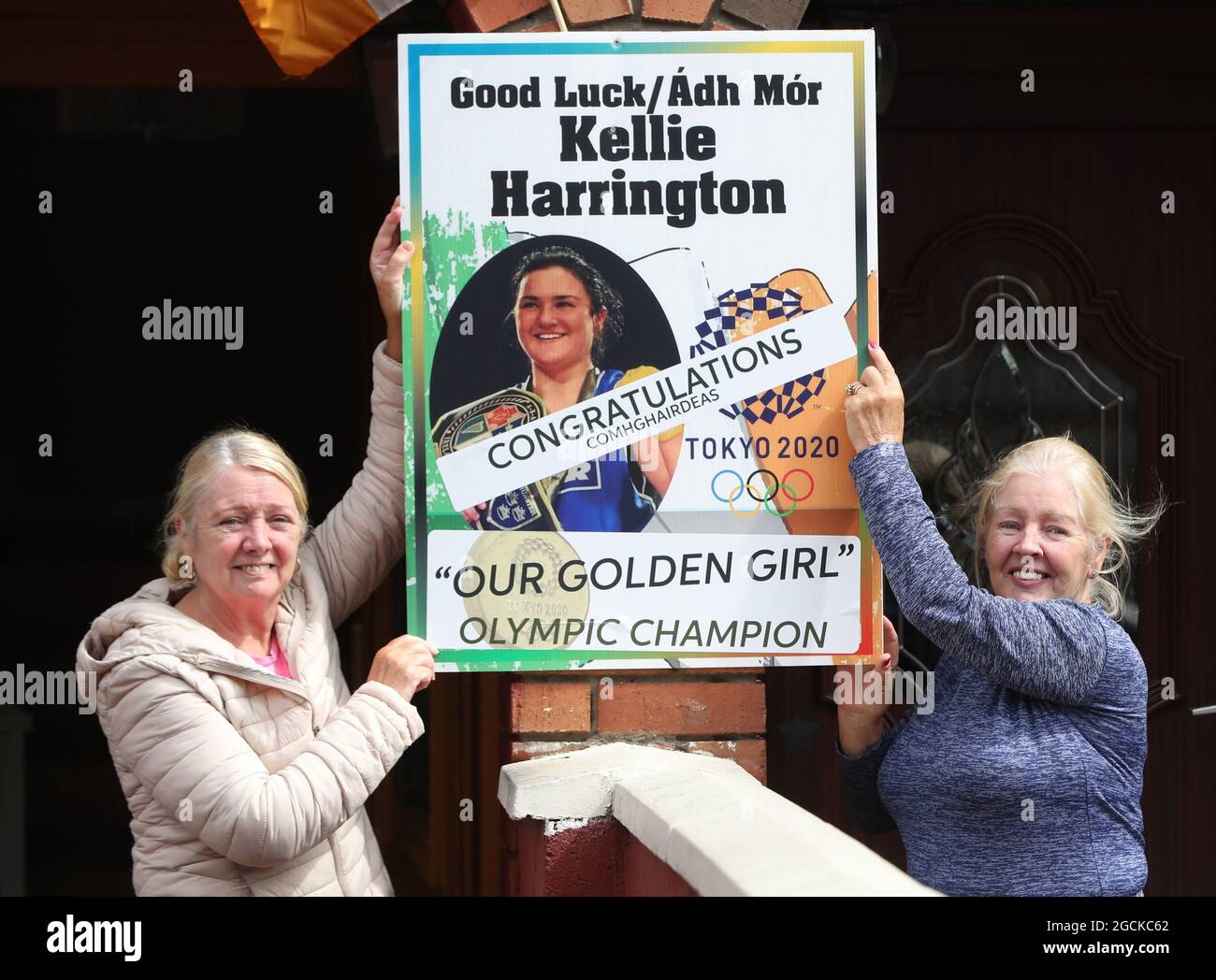 Sisters (left to right) Marie Fox and Kay Walsh putting up a poster ...