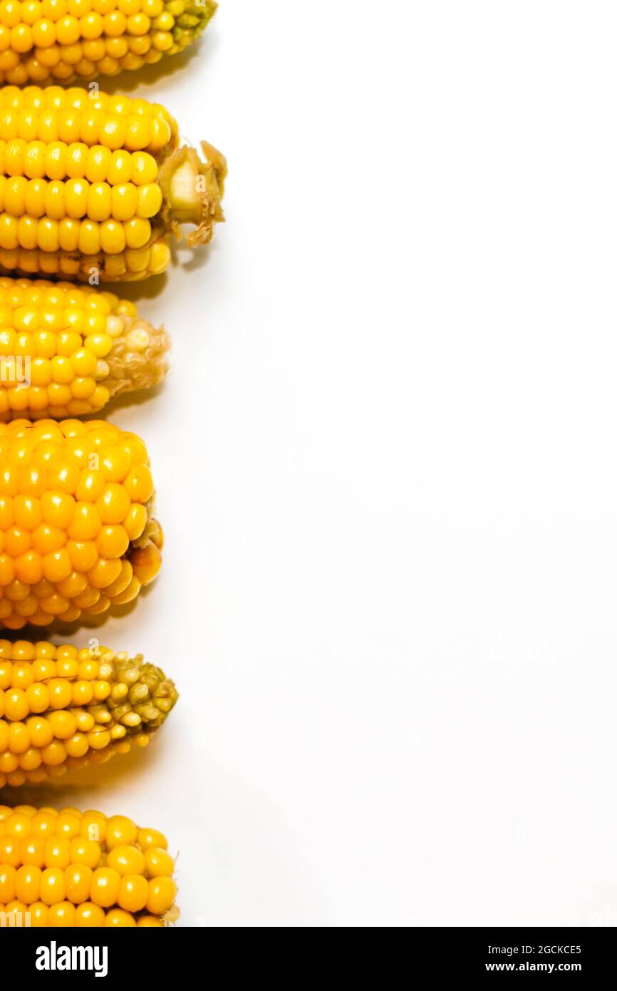 Boiled yellow sweet corn on a white background. Texture. Creative food ...