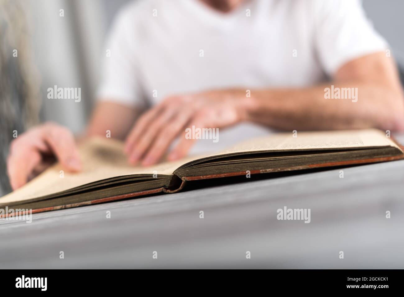 Man sitting reading a book Stock Photo - Alamy