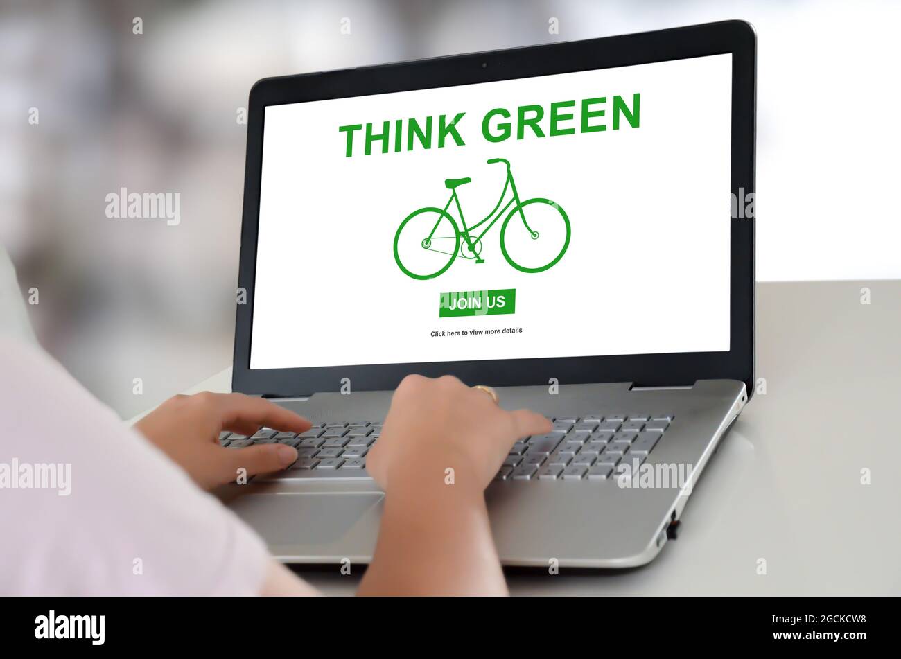 Woman using a laptop with think green concept on the screen Stock Photo ...