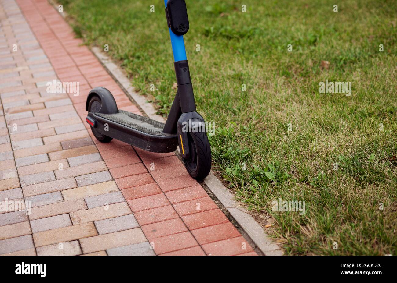 Electric scooter on sidewalk. front view Stock Photo - Alamy