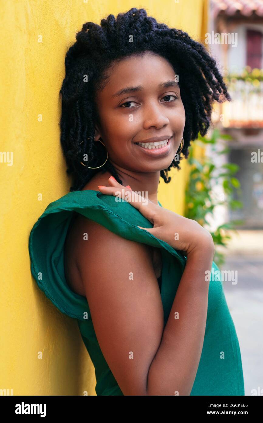 Close upside portrait of beautiful smiling young Black Woman leaning ...