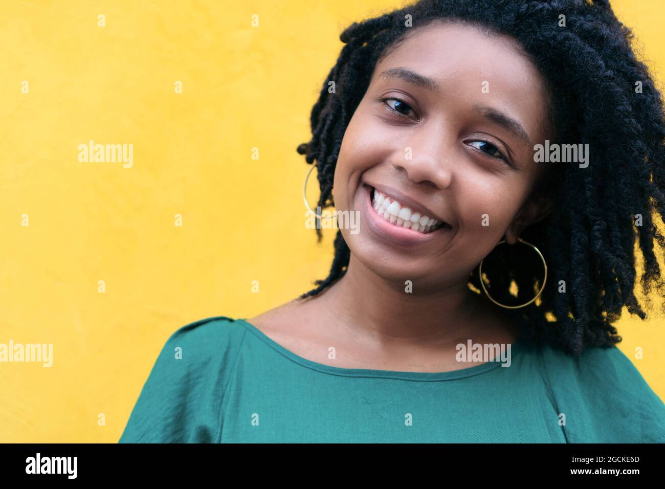 Close upside portrait of beautiful smiling young Black Woman leaning ...