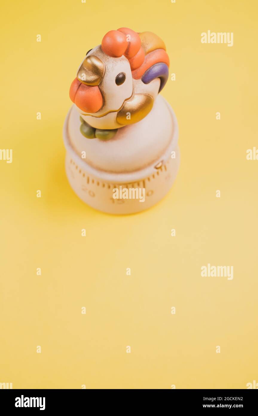 Top view of a kitchen timer in a cute chicken shape on yellow ...