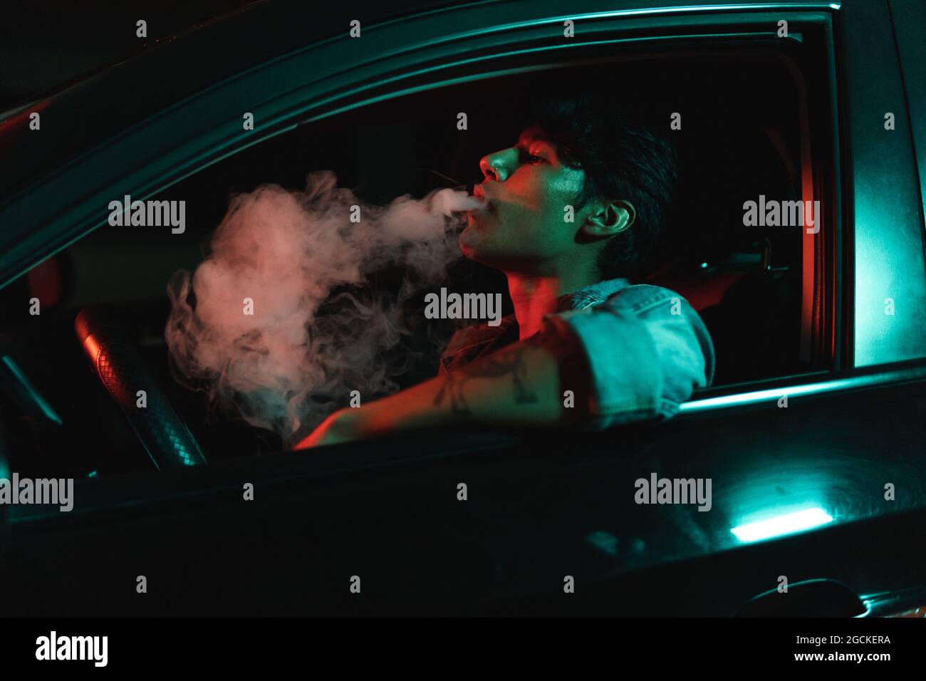 Young male smoking in car hi-res stock photography and images - Alamy