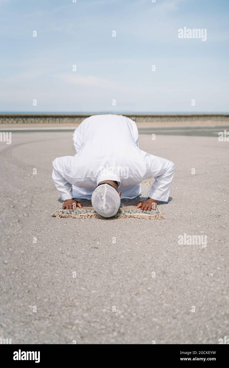 Muslim man on prayer mat hi-res stock photography and images - Alamy