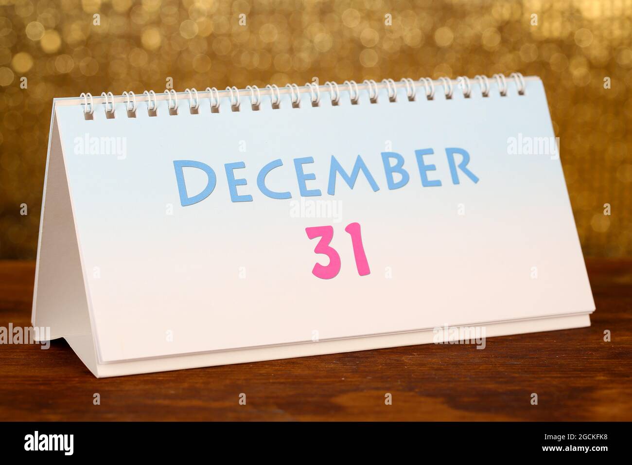 New Year calendar on wooden table, on shiny golden background Stock ...