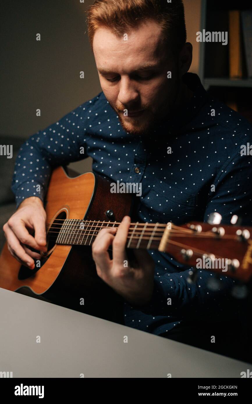 Vertical close-up portrait of guitarist singer male playing acoustic ...