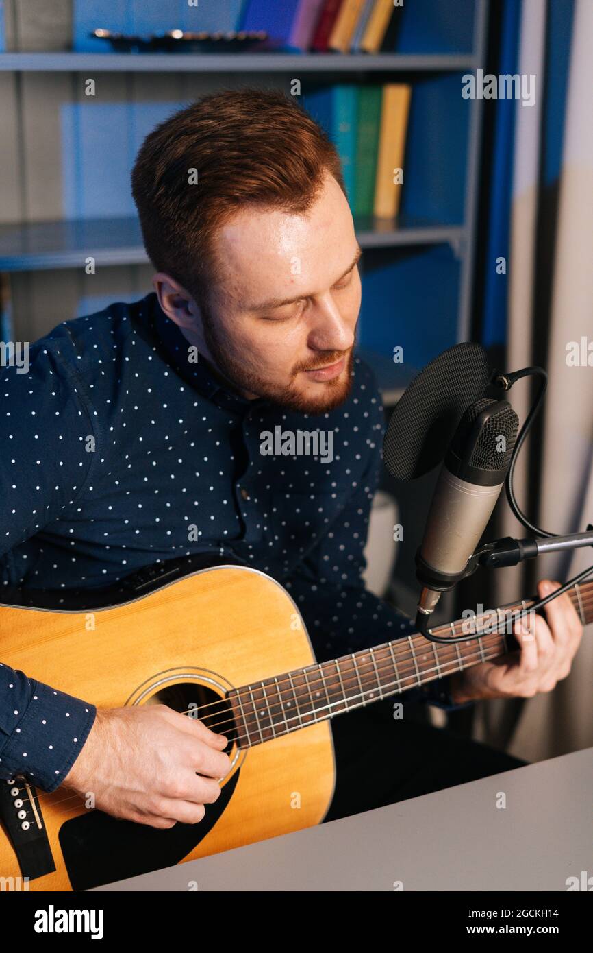 Vertical portrait of talented guitarist singer man playing on acoustic ...