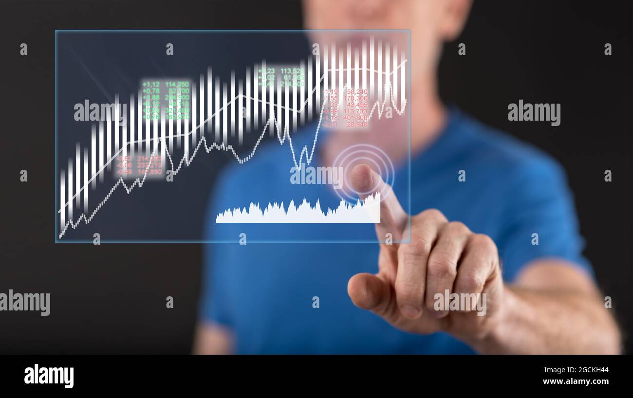 Man touching a stock market concept on a touch screen with his finger ...
