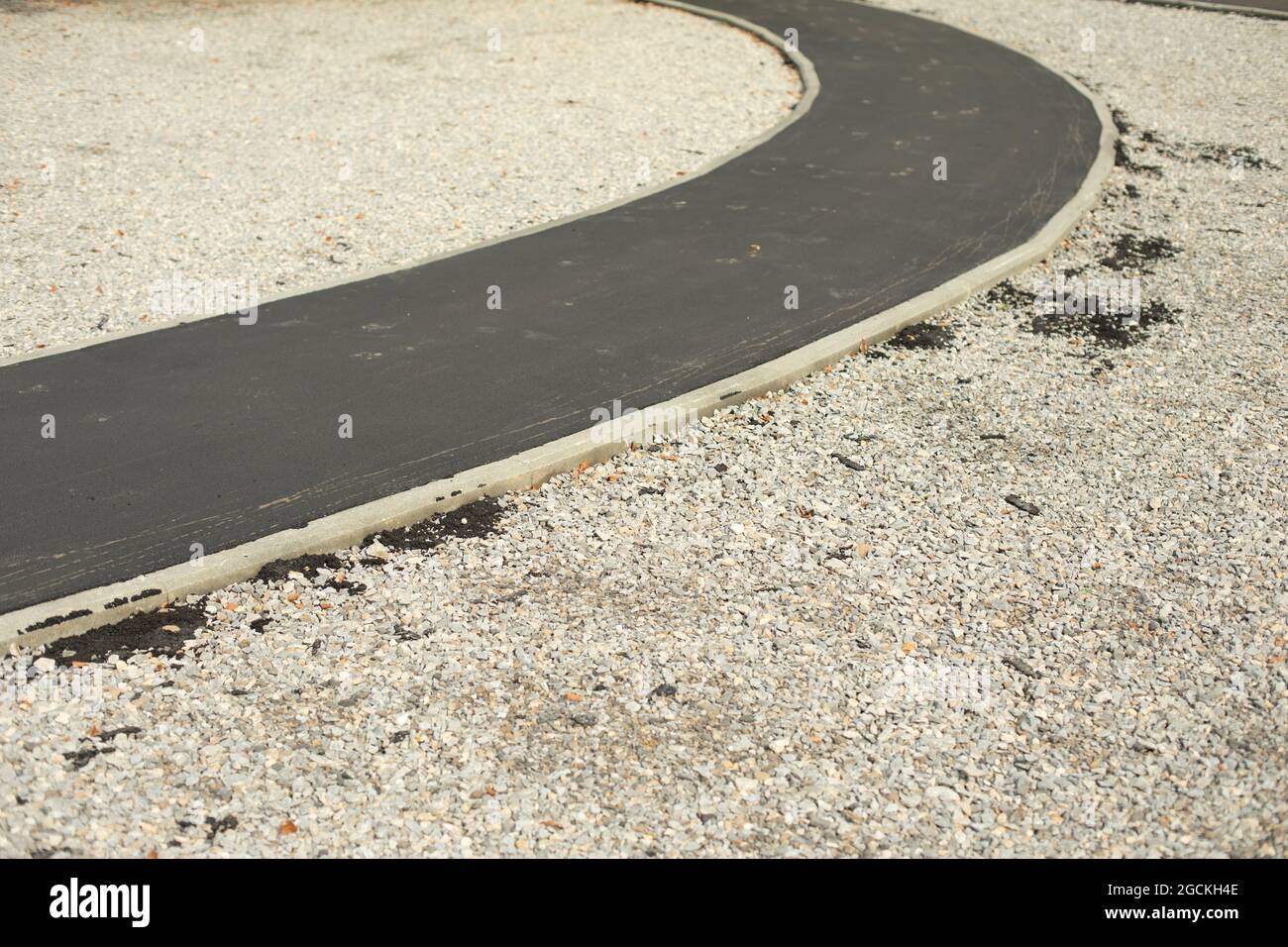New asphalt road in the park. Narrow park path for cyclists. Repaired ...