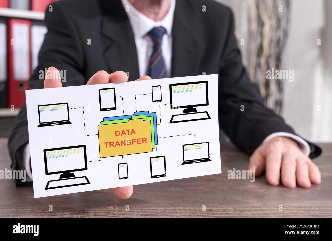 Businessman showing an index card with data transfer concept Stock ...