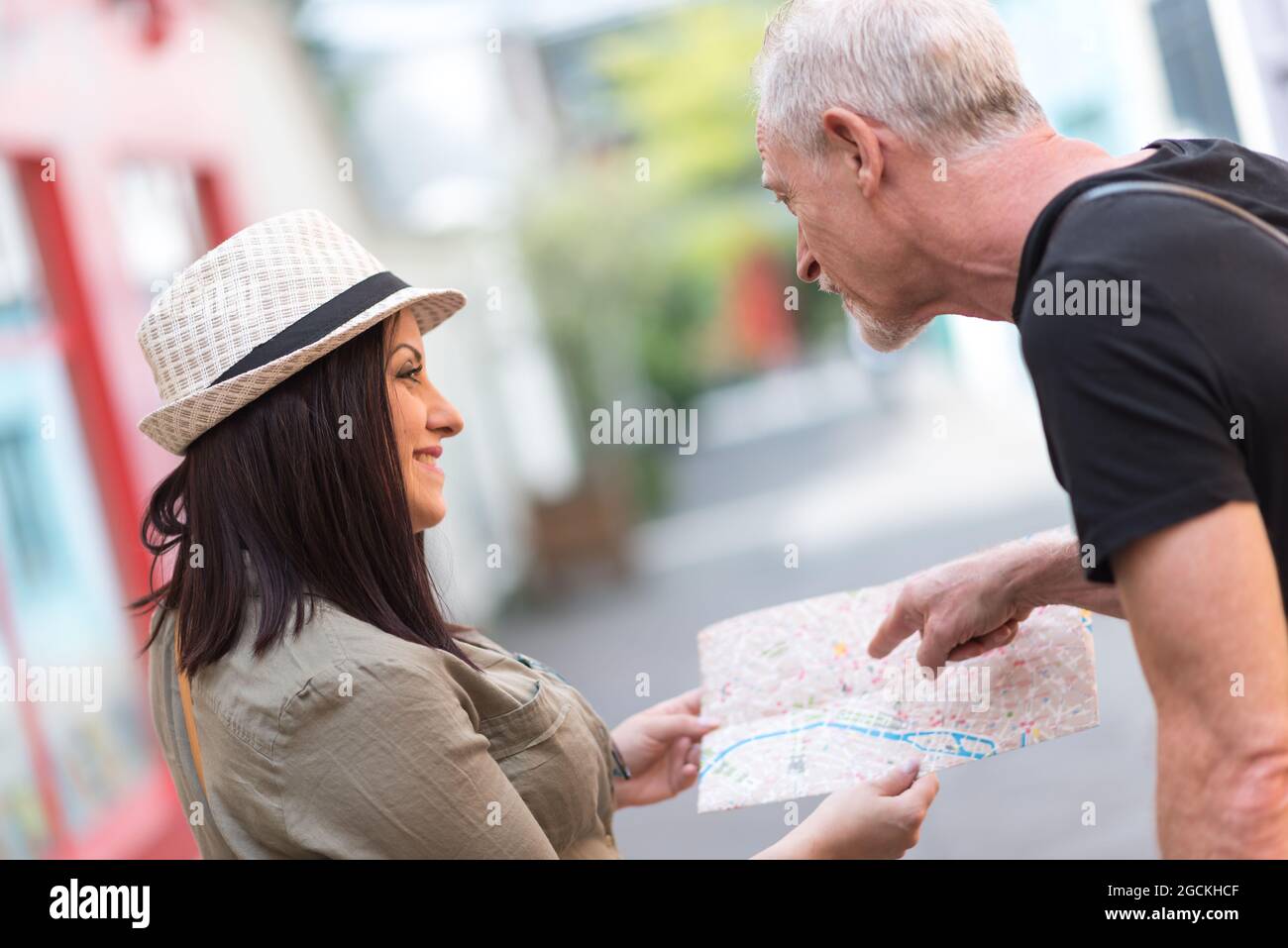 Pretty young woman asking for direction on city map Stock Photo - Alamy