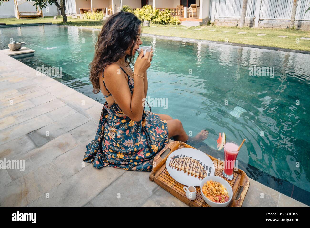 Side view female traveler with hot drink looking away while sitting on ...