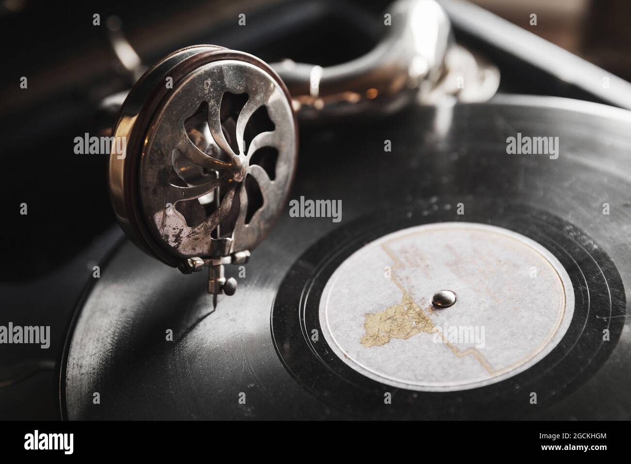 Vintage phonograph with black vinyl record plays an old music, close up ...