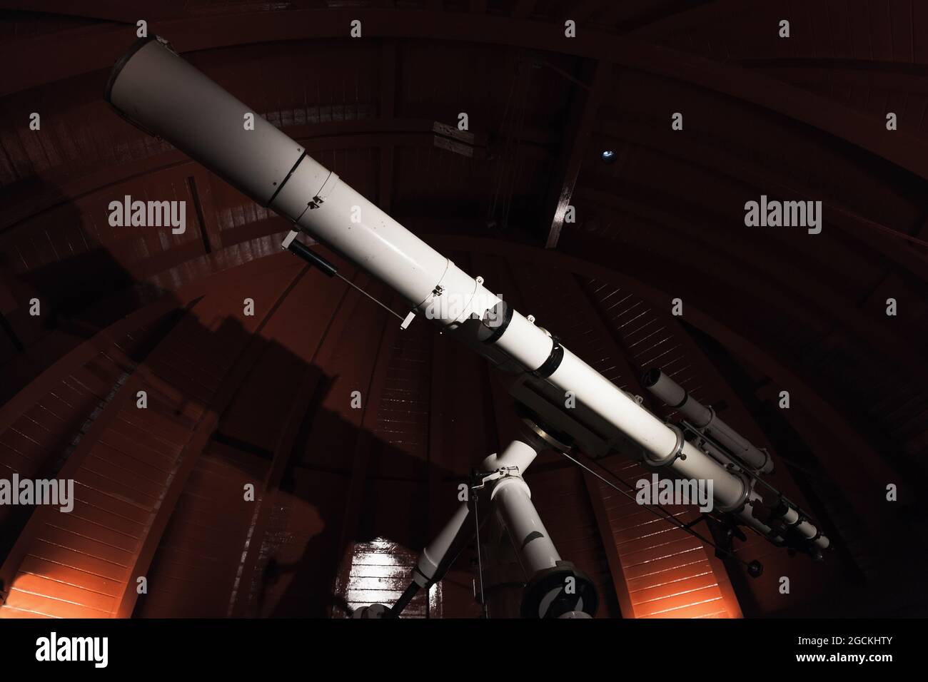 Professional telescope is in an observatory with window open to the ...